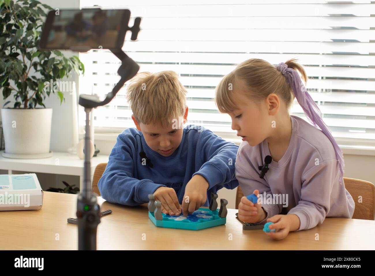 Kids play a new board game for their blog, recording a fun and ...