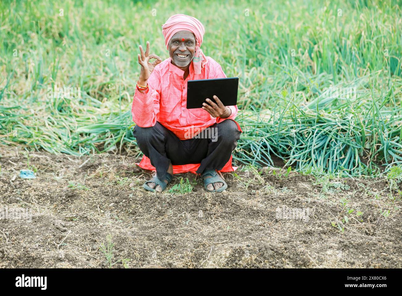 Indian farmer holding tablet Stock Photo - Alamy