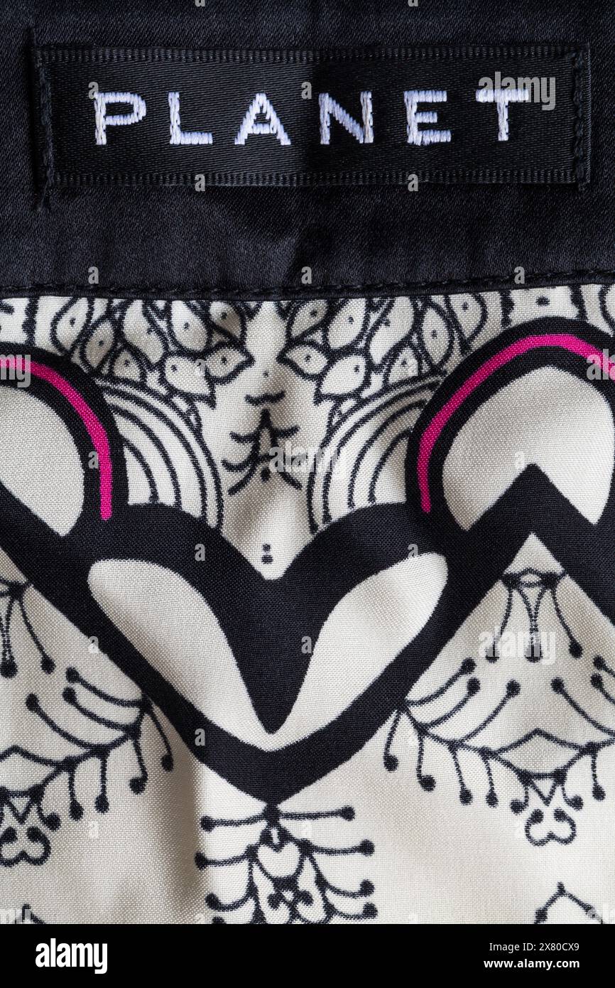 Planet label in woman's top clothing garment Stock Photo - Alamy