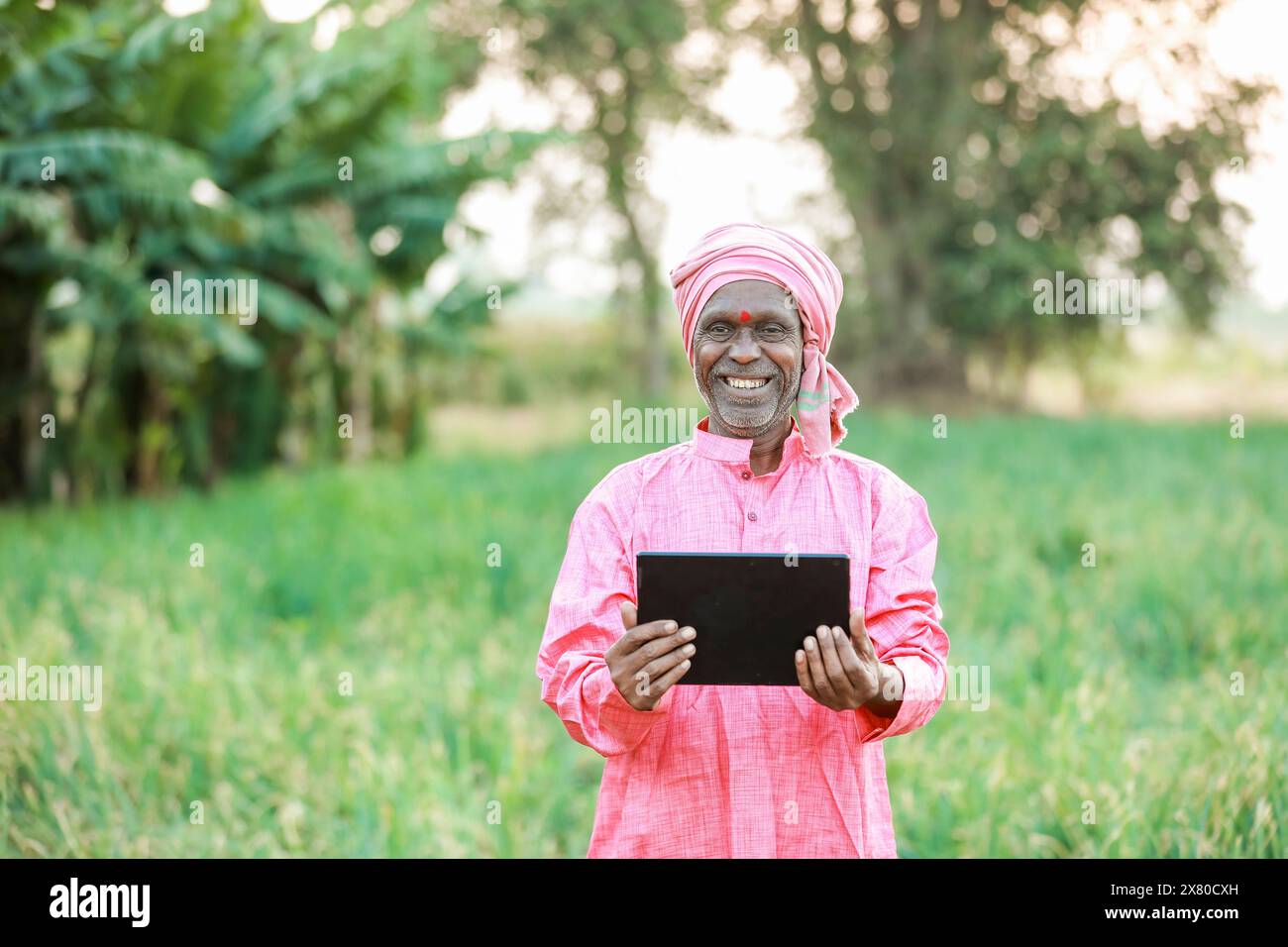 Indian farmer holding tablet Stock Photo - Alamy