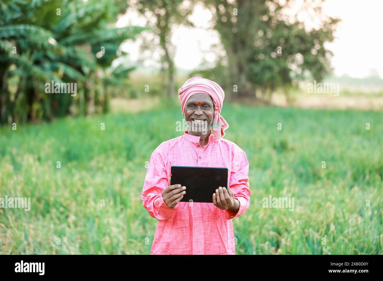 Indian farmer holding tablet Stock Photo - Alamy