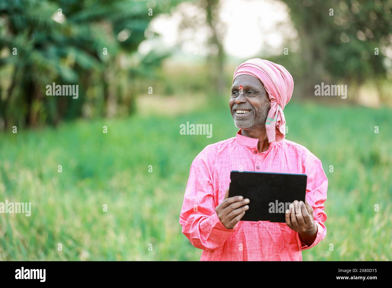Indian farmer holding tablet Stock Photo - Alamy