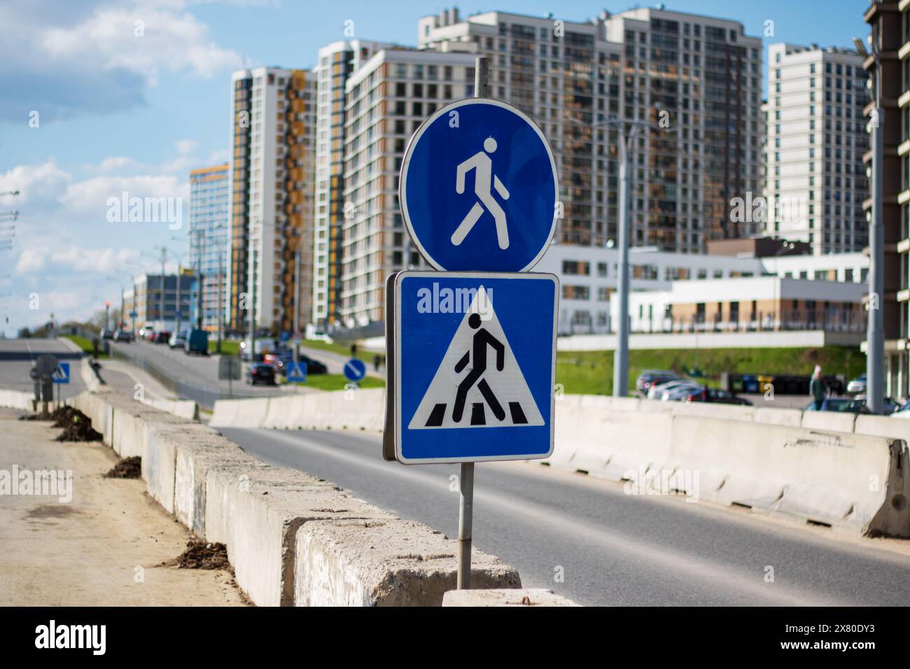 In front of a building under construction, there is a blue and white ...