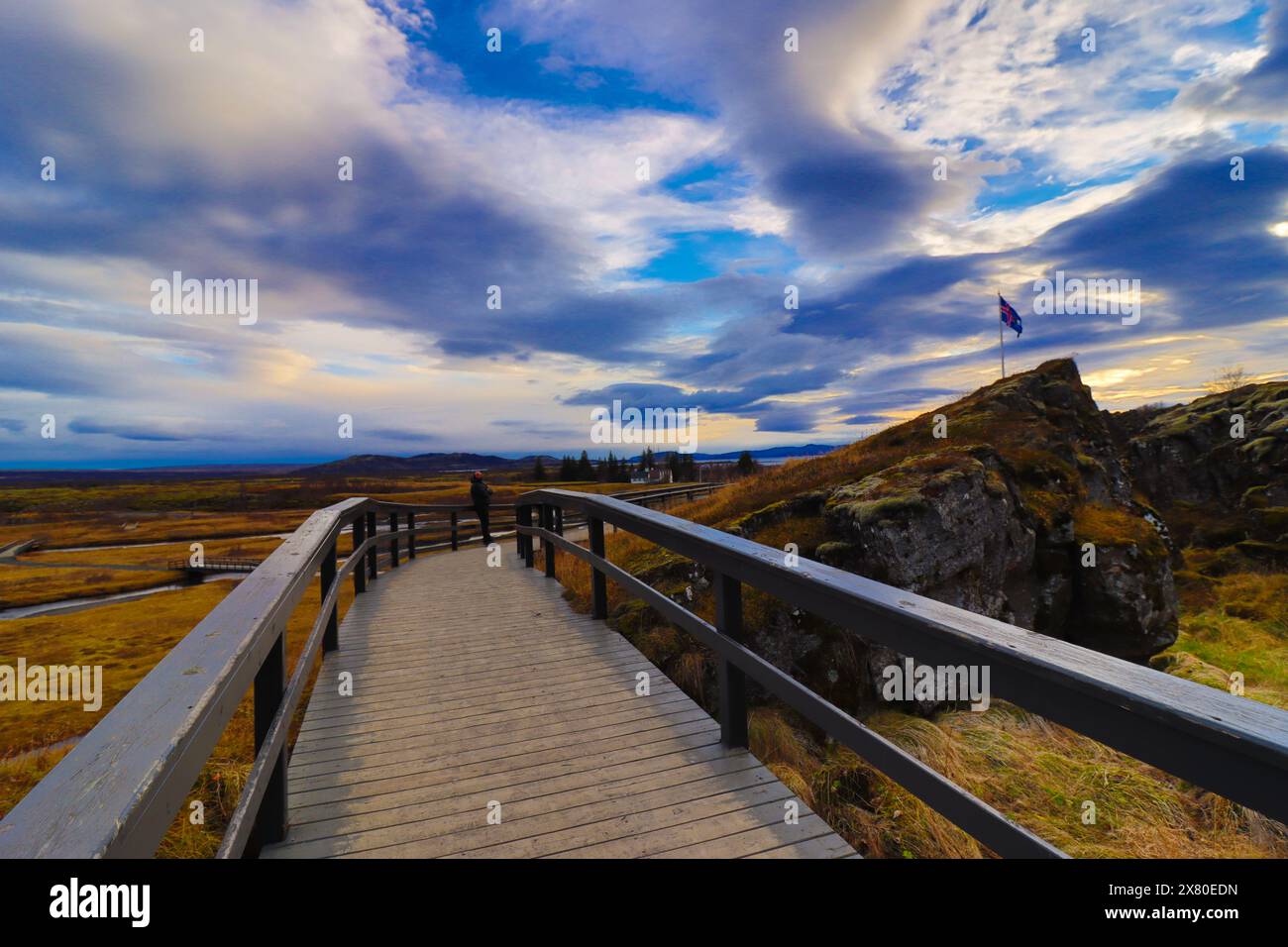 Wooden footbridge in Thingvellir National Park with the Icelandic Flag ...