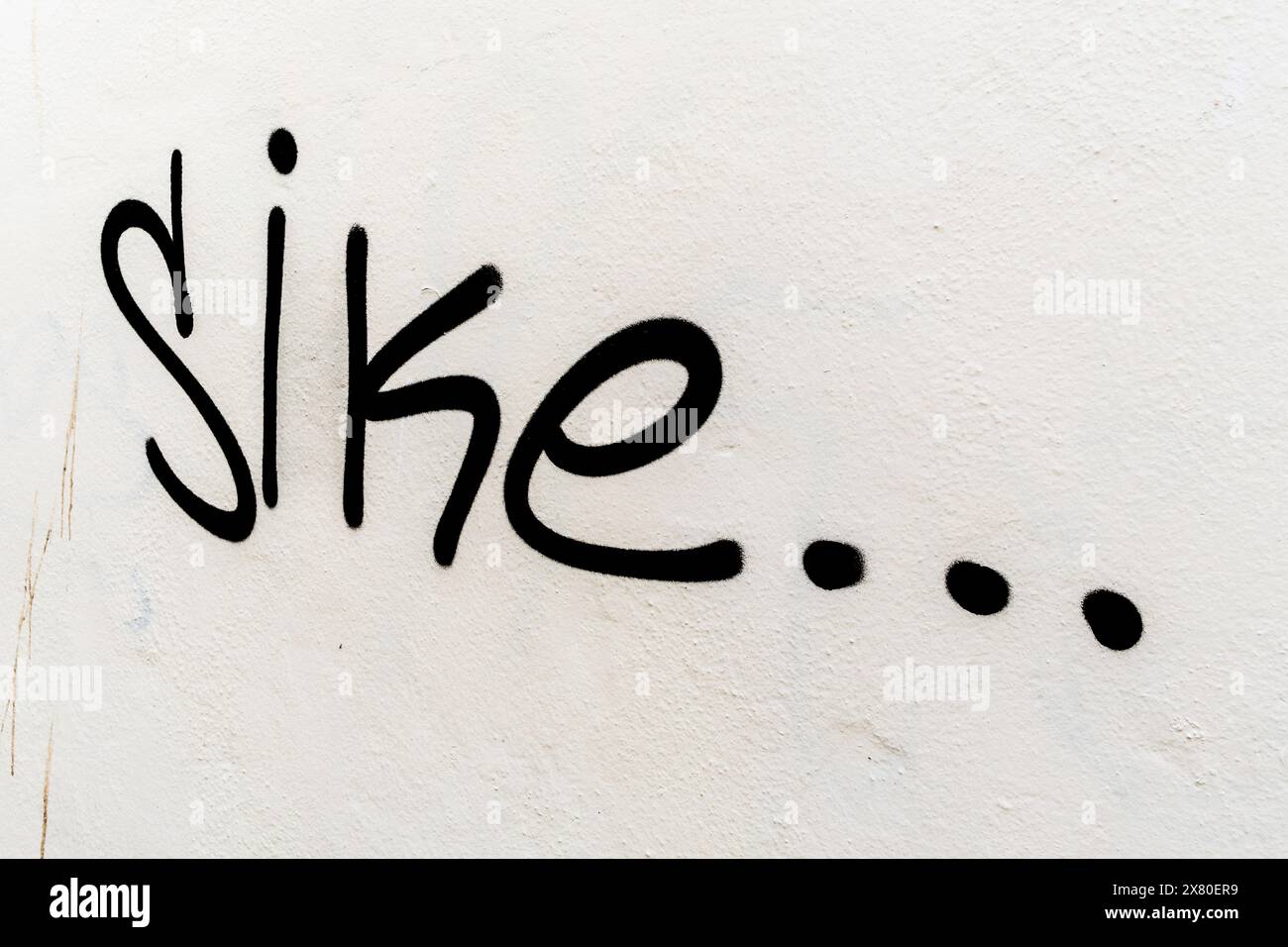 A tag sprayed in black paint on a wall in Newquay in Cornwall in the UK ...
