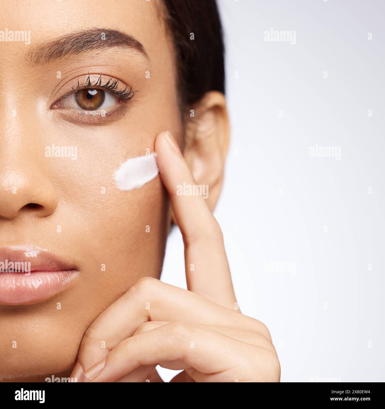 Half, woman and sunscreen on face for skincare and dermatology in ...