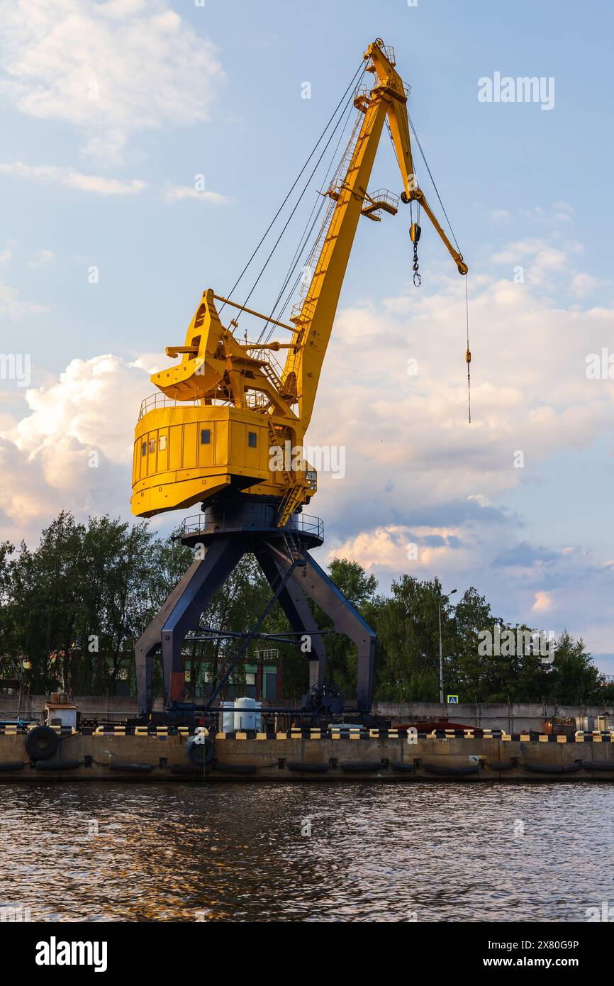 Yellow portal crane on blue base stands in the harbor. Kaliningrad ...