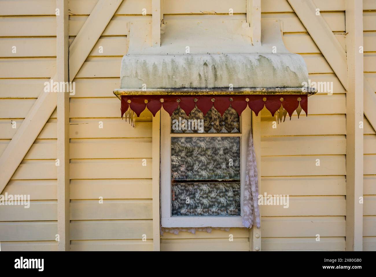 A steel hood over an old window provides cover from heat and rain at ...