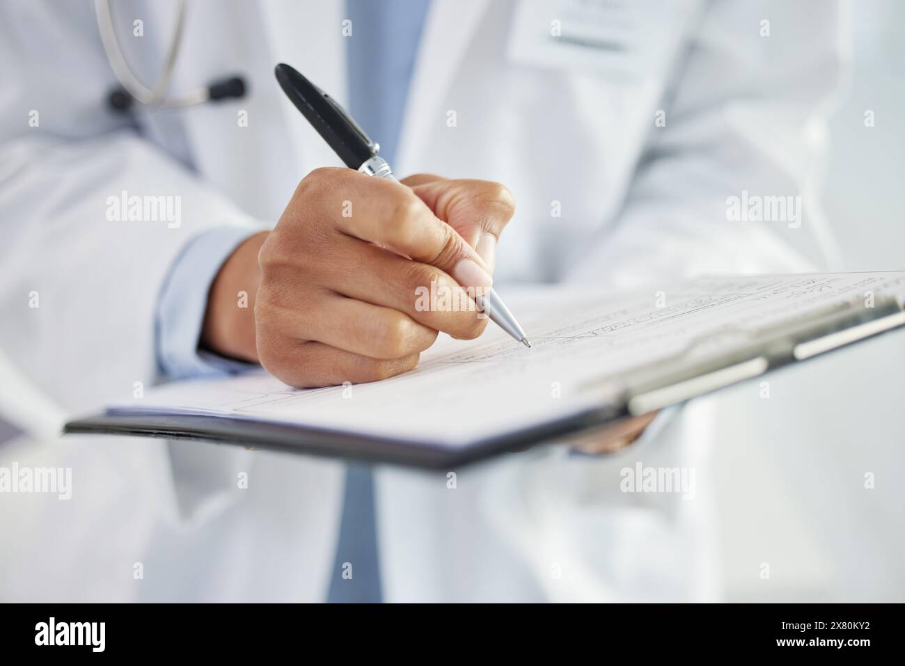 Hands, doctor and writing on paperwork in hospital for insurance ...
