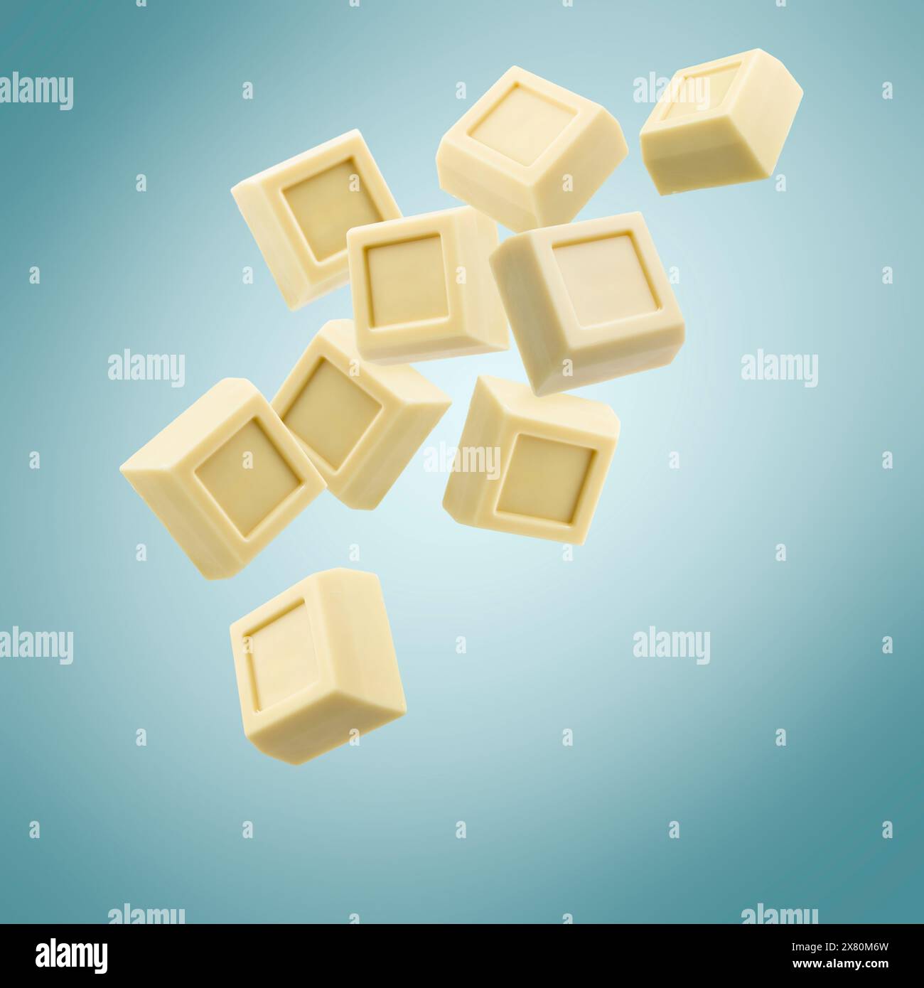 White chocolate blocks flying on blue background Stock Photo - Alamy