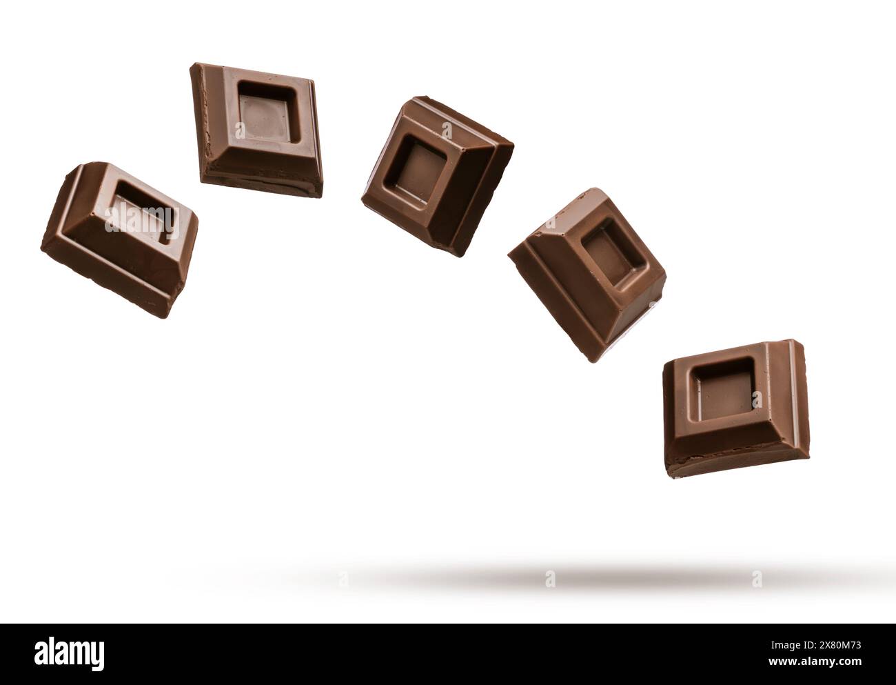 Dark chocolate blocks flying on white background Stock Photo - Alamy