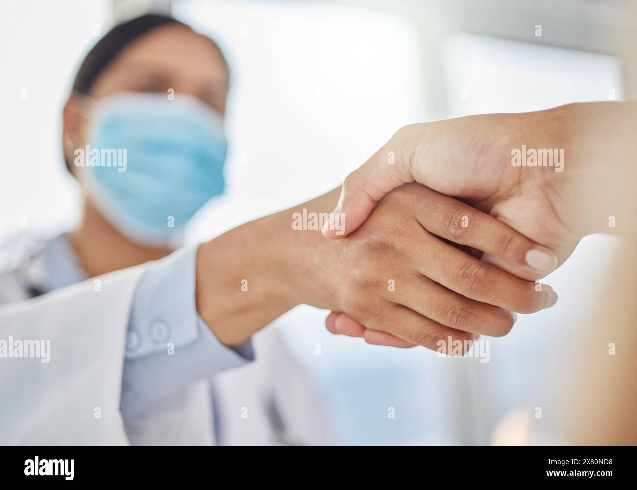 Doctor, woman and handshake for congratulation on protection ...