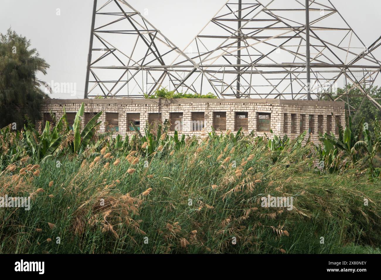 Abandoned industrial block building at the base of electrical pylon on ...