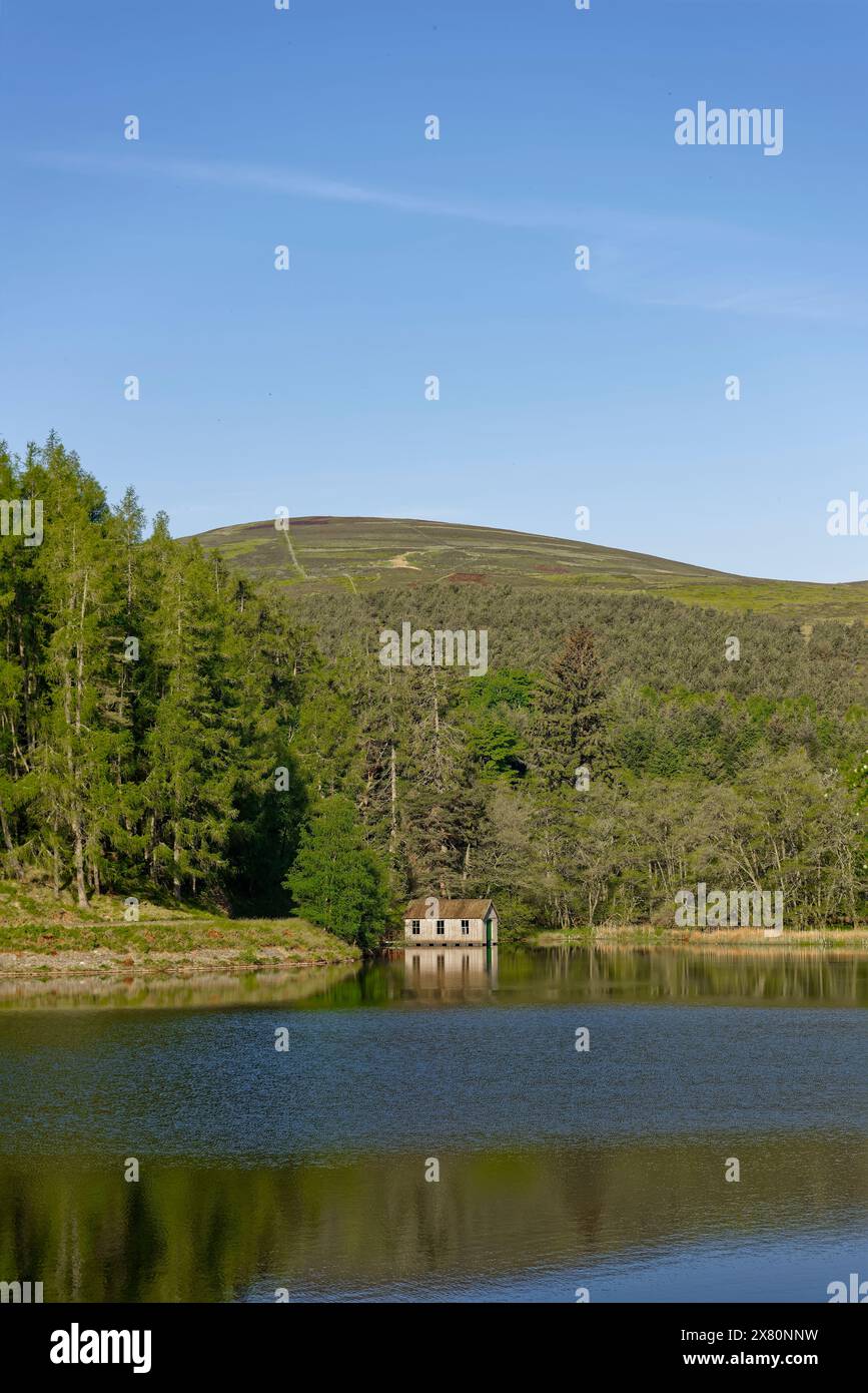 The traditional Wooden Boathouse on the Glen Ogil Reservoir, hidden ...