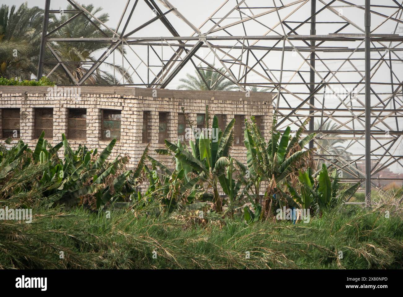 Abandoned industrial block building at the base of electrical pylon on ...