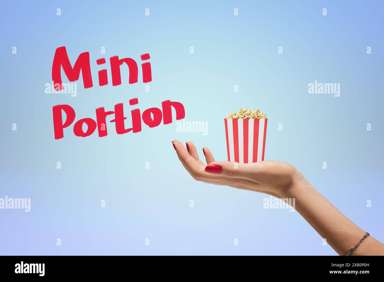 Hand presenting a mini popcorn box Stock Photo - Alamy