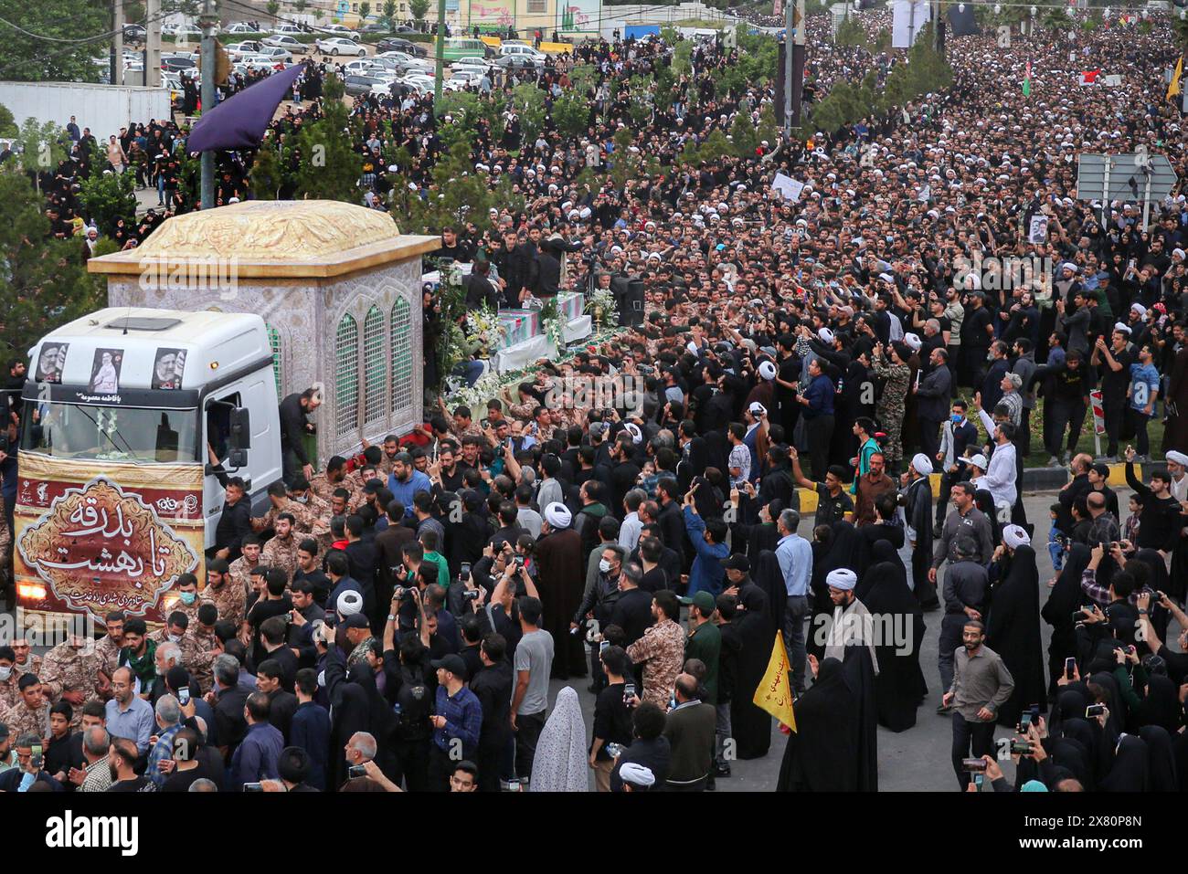 May 22, 2024, Qom, Iran: Iranian mourners attend the funeral procession ...