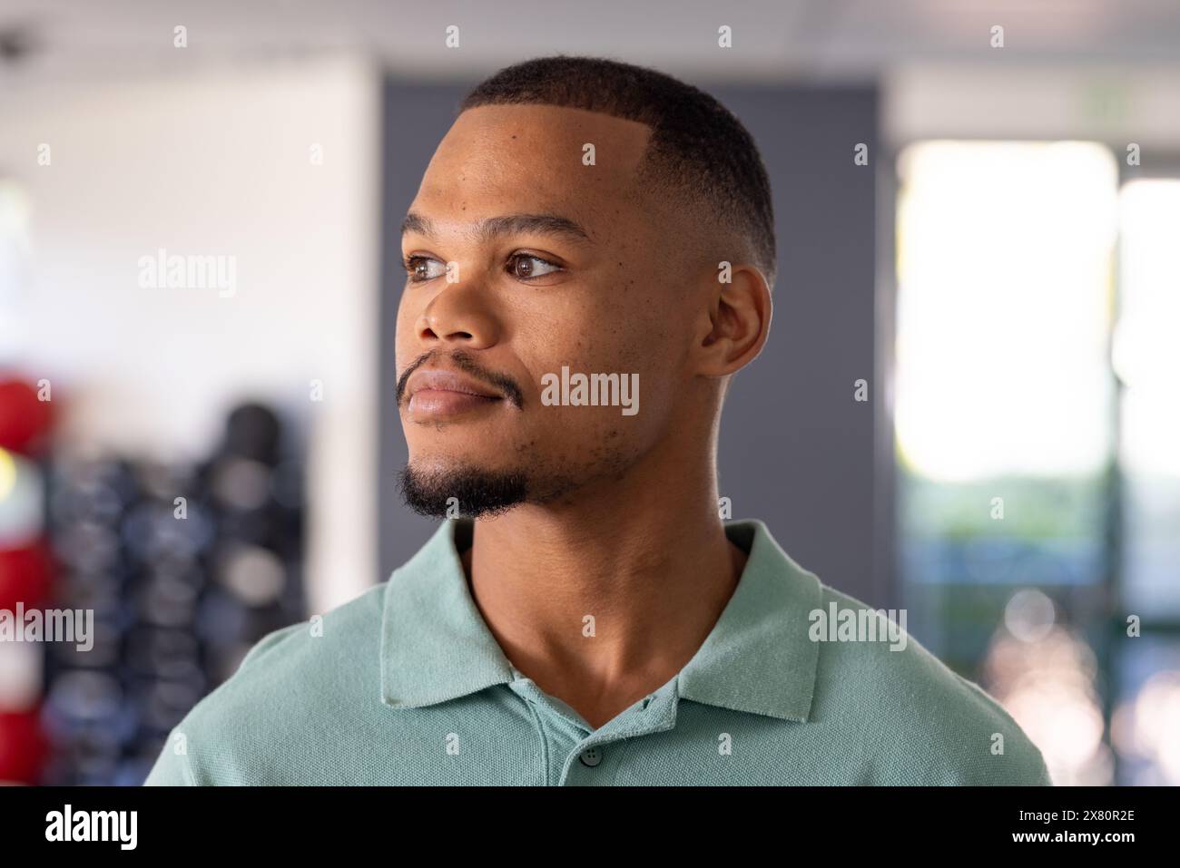 A biracial male physical therapist at gym rehabilitation center ...