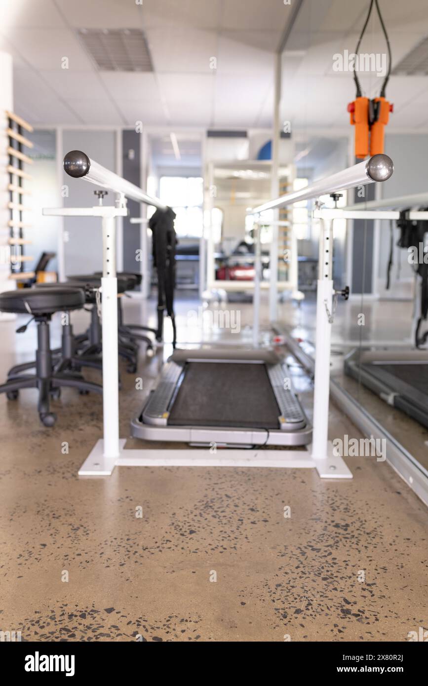 A rehabilitation treadmill and walking frame stand ready at gym ...