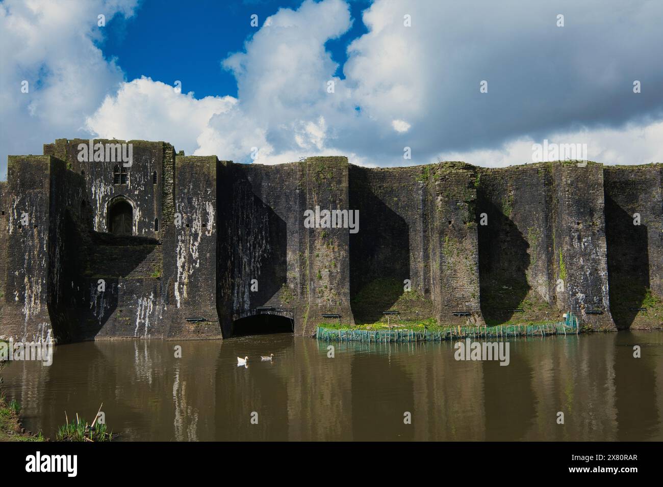 Exterior view of Caerphilly Castle wall and moat in early Spring, Wales ...