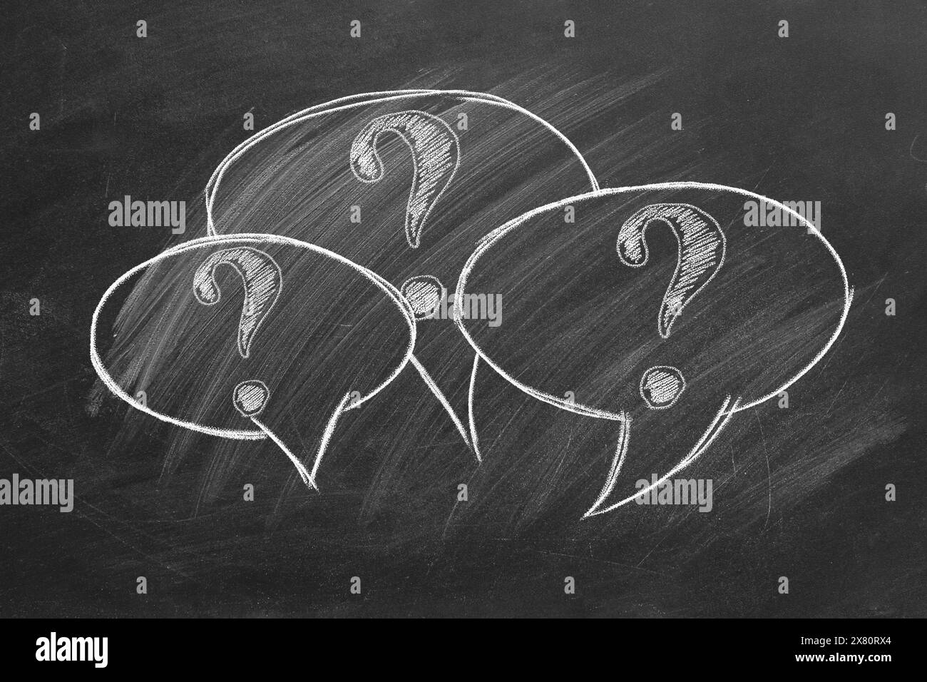 Three chalk-drawn speech bubbles on a blackboard, each containing a ...