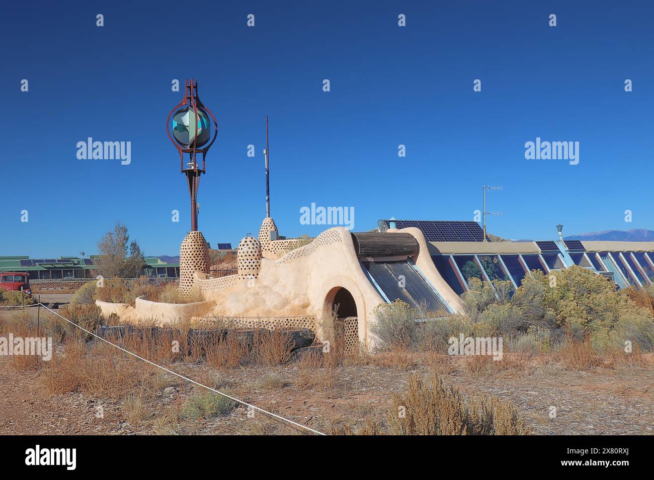 Earthship building with greenhouse and solar panels, part of the ...
