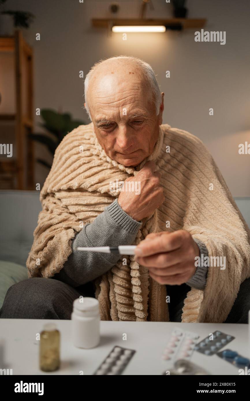 Sick, flu man has headache, fever, flu and checking thermometer ...