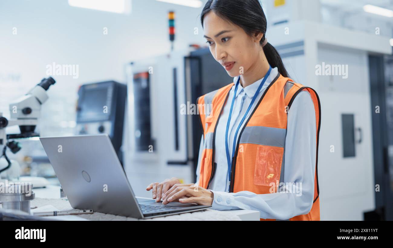 Research and Development Specialist Using Laptop to Operate a Heavy ...
