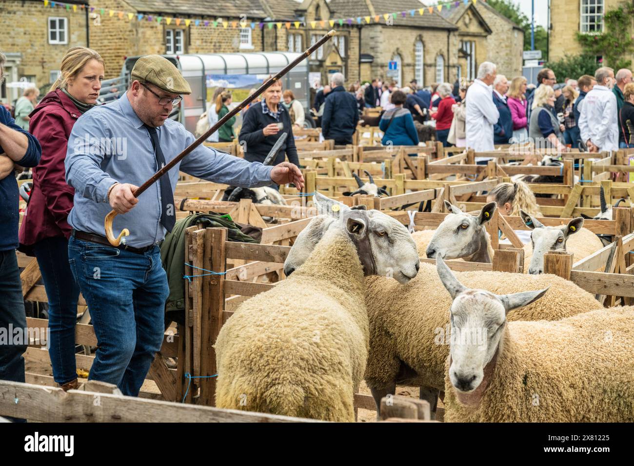 Male judge wearing a traditional flat cap, holding a shepherd's crook ...