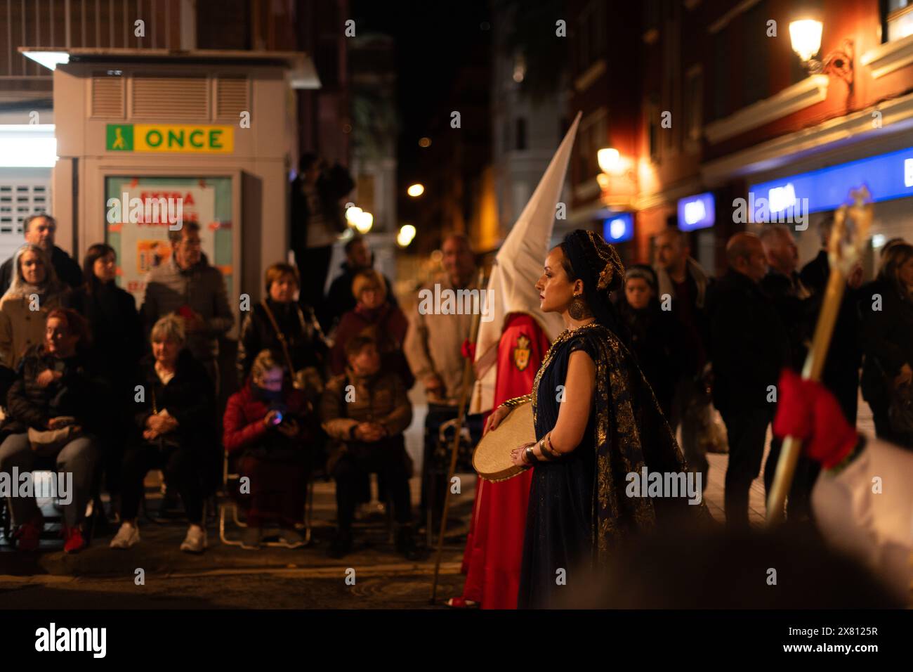Participants with white capirotes and red dresses during Easter Friday ...