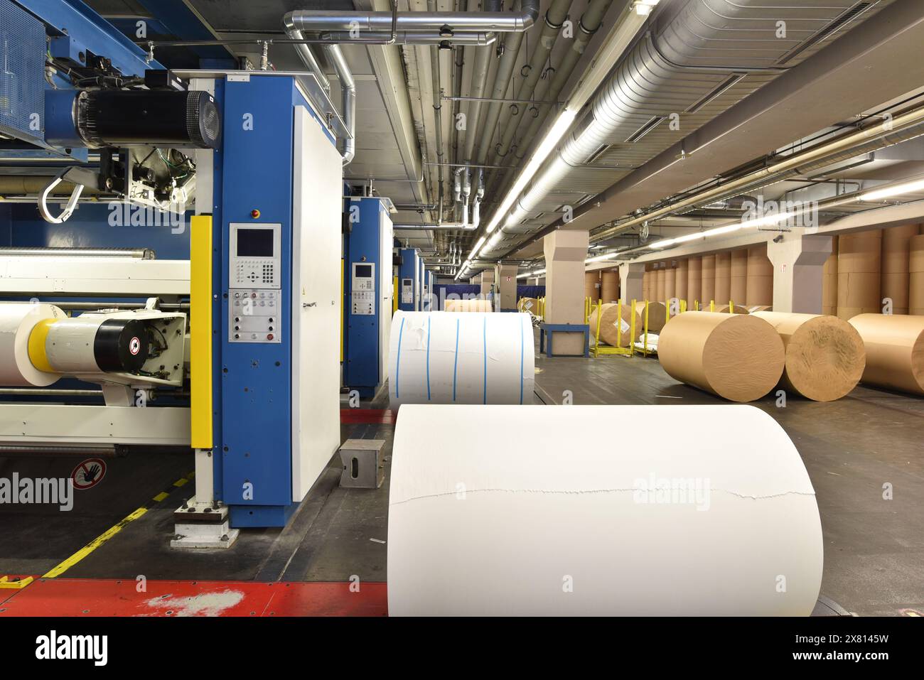 paper rolls and offset printing machines in a large print shop for ...