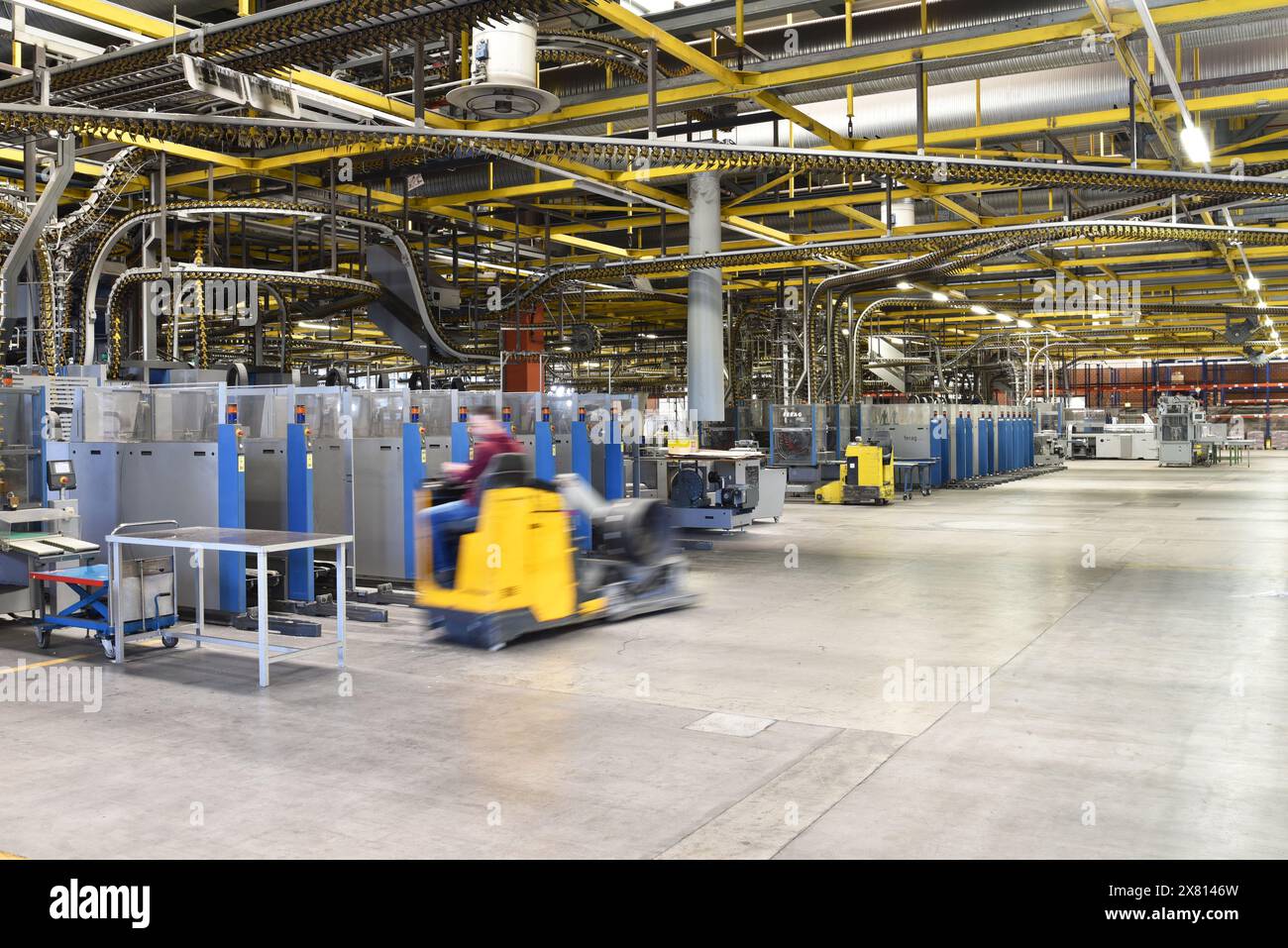 modern machines for transportation in a large print shop for production ...