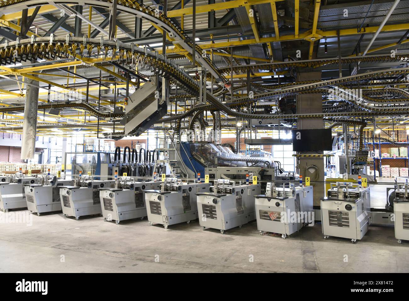 modern machines for transportation in a large print shop for production ...