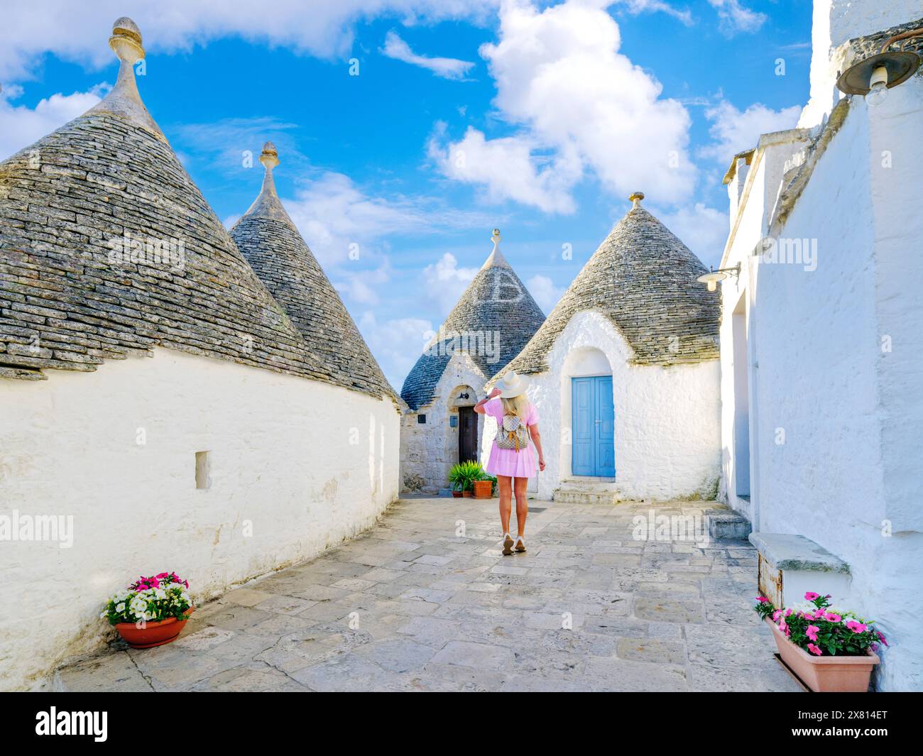 Woman visiting Trulli Homes of Alberobello, UNESCO World Heritage Site ...