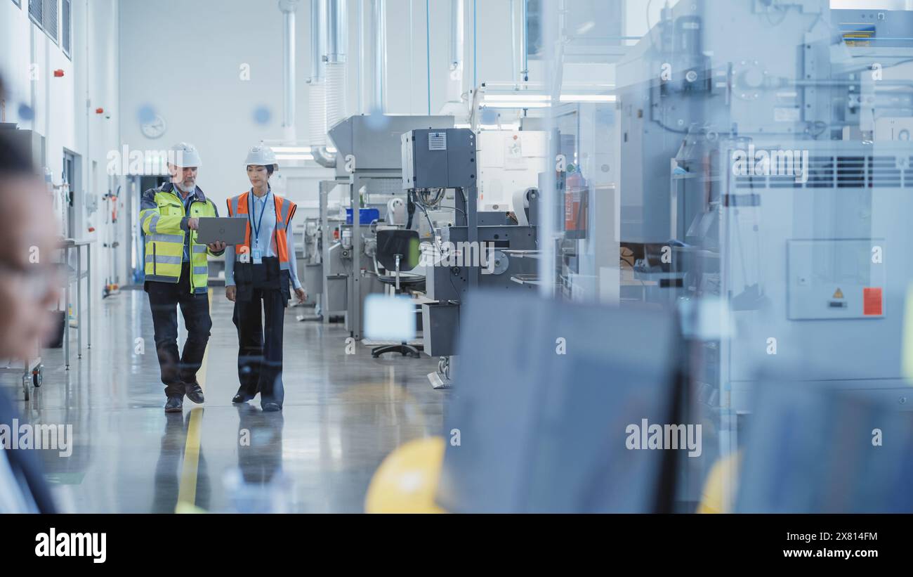 Two Professional Heavy Industry Employees Wearing Hard Hats at Factory ...