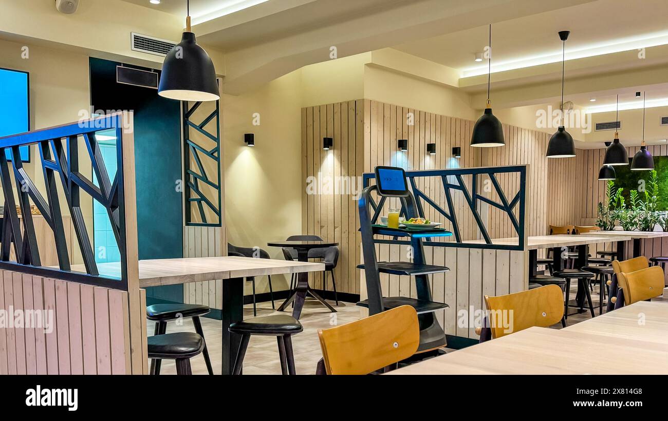 Robot waiter serve food at modern restaurant, delivery order to ...