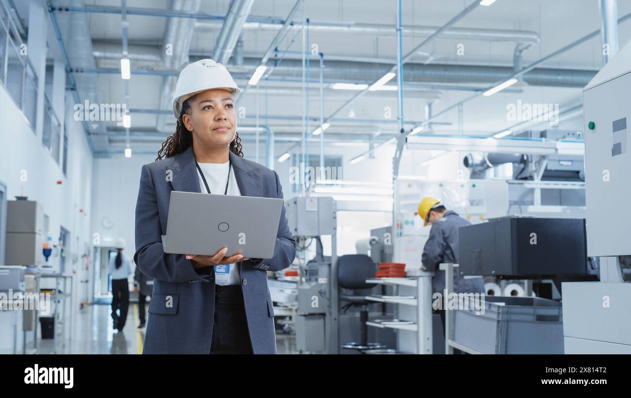 Portrait of a Happy Black Female Engineer in Hard Hat Standing and ...