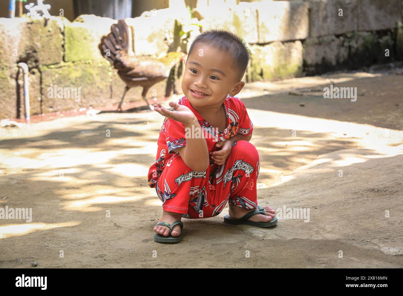 A young Filipino boy play with the camera by posing & asking for more ...