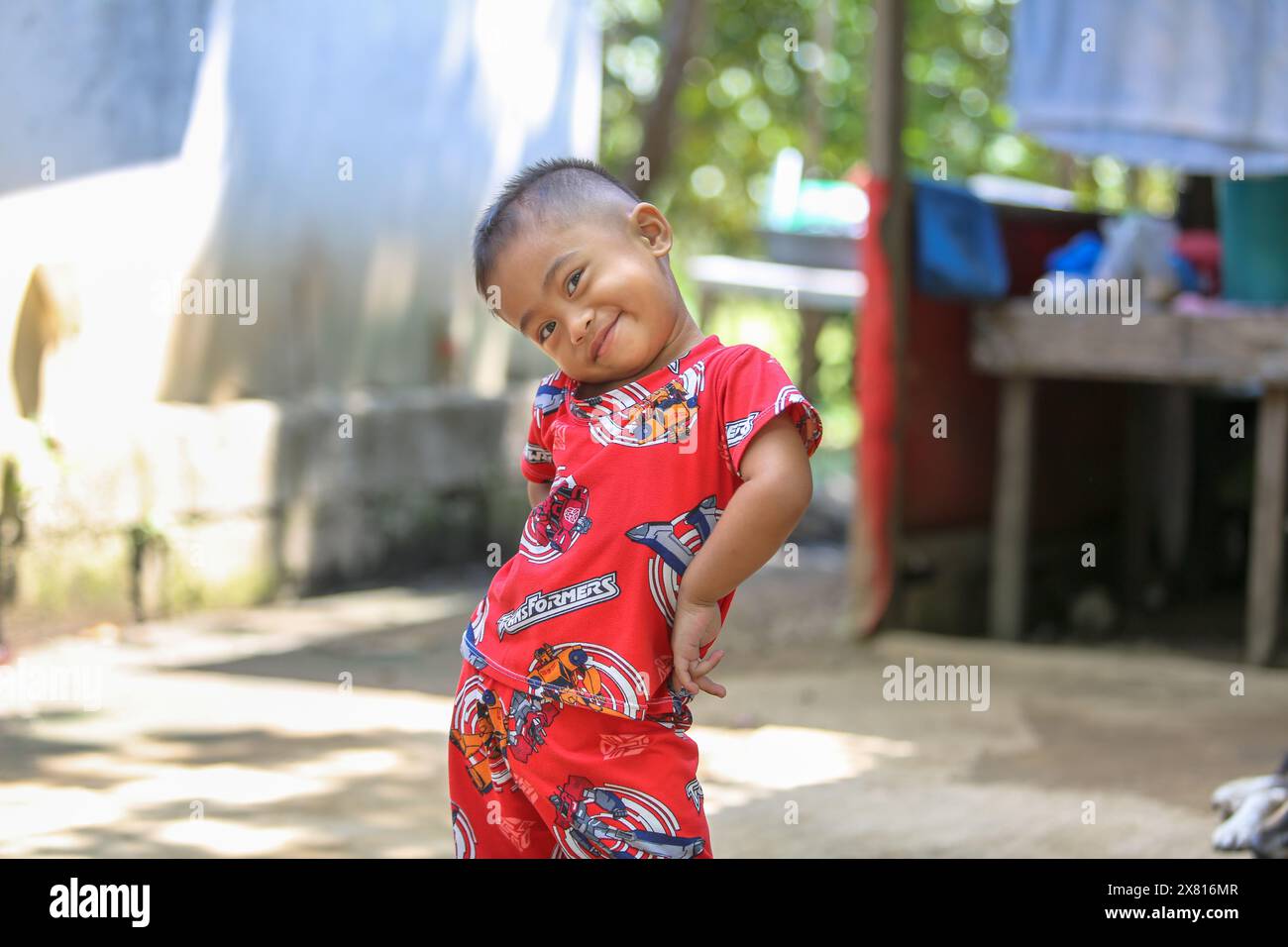 A young Filipino boy play with the camera by posing & asking for more ...