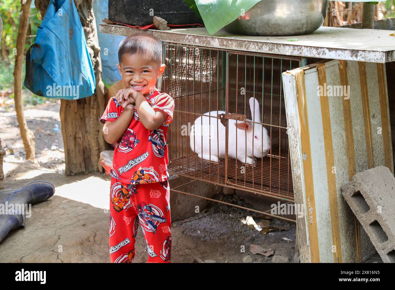 A young Filipino boy play with the camera by posing & asking for more ...