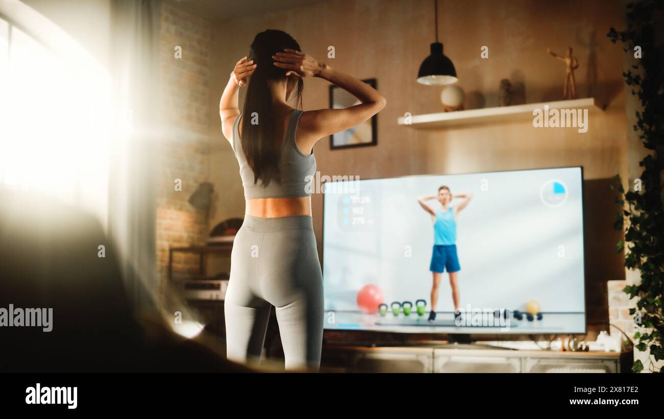 Active Girl Watching Personal Trainer through Online Video Tutorial ...