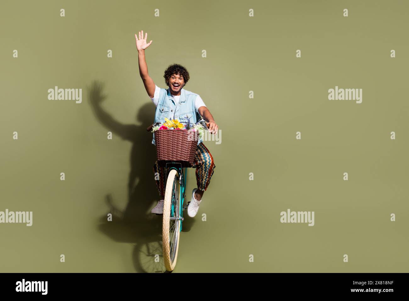 Full length photo of nice young male cycling have fun wave hand dressed ...