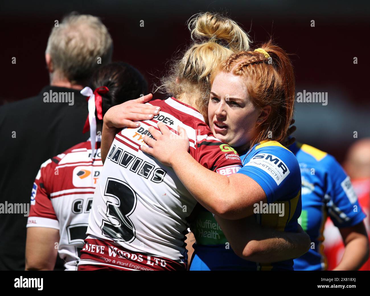 Wigan Warriors' Anna Davies embraces Leeds Rhinos' Caitlin Casey ...