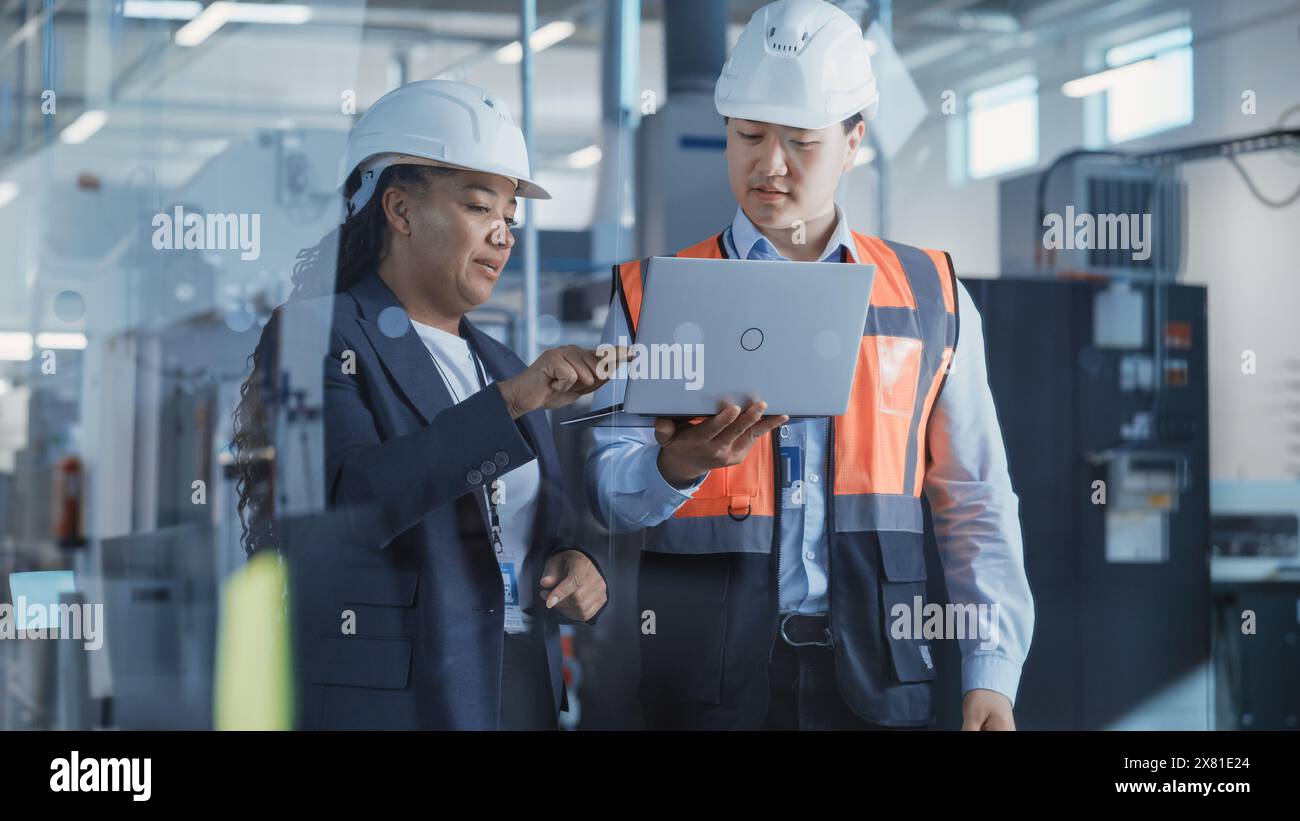 Two Professional Heavy Industry Engineers Wearing Safety Uniform and ...