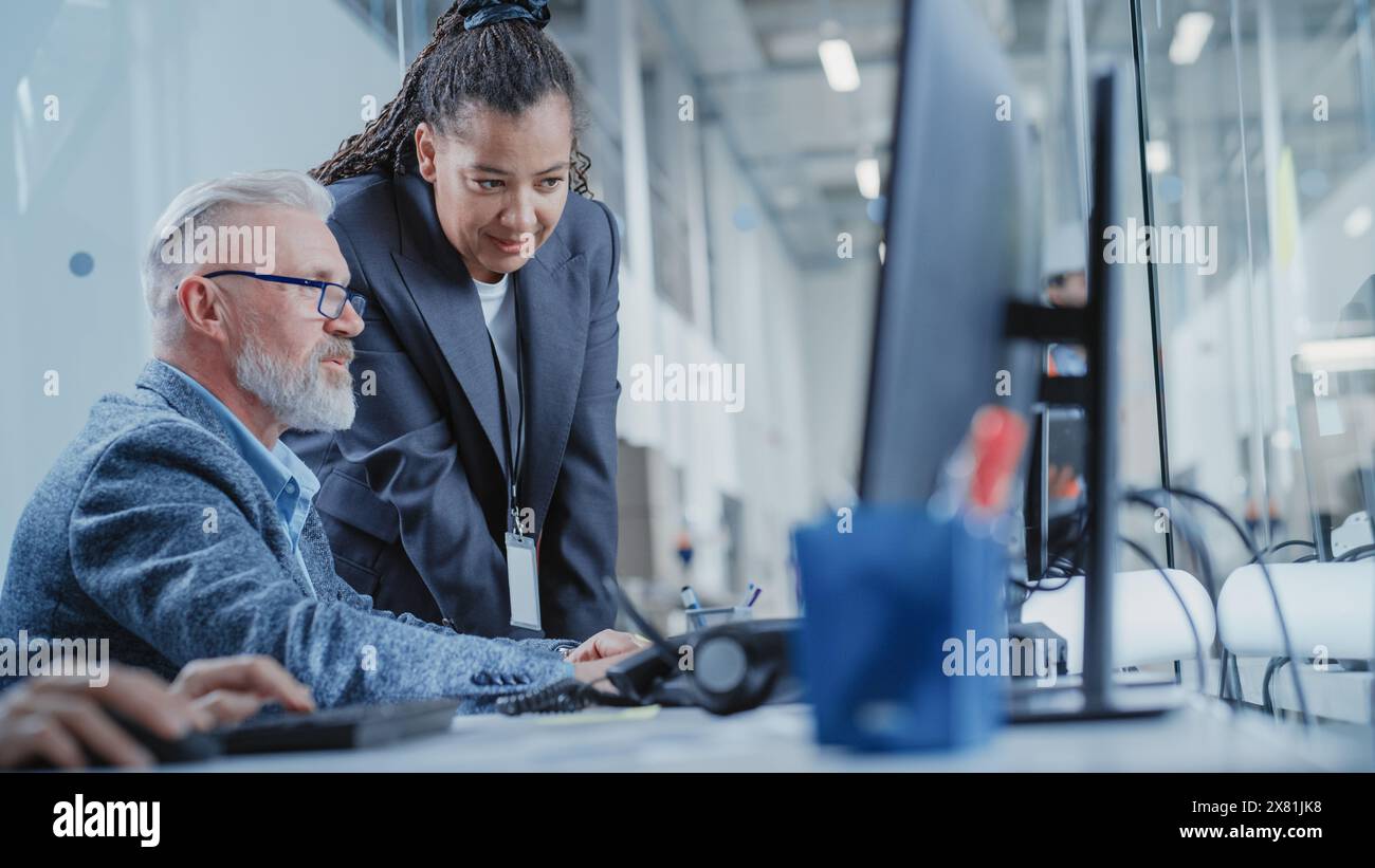 Factory Office Facility: Industrial Engineers Drafting Blueprints of a ...