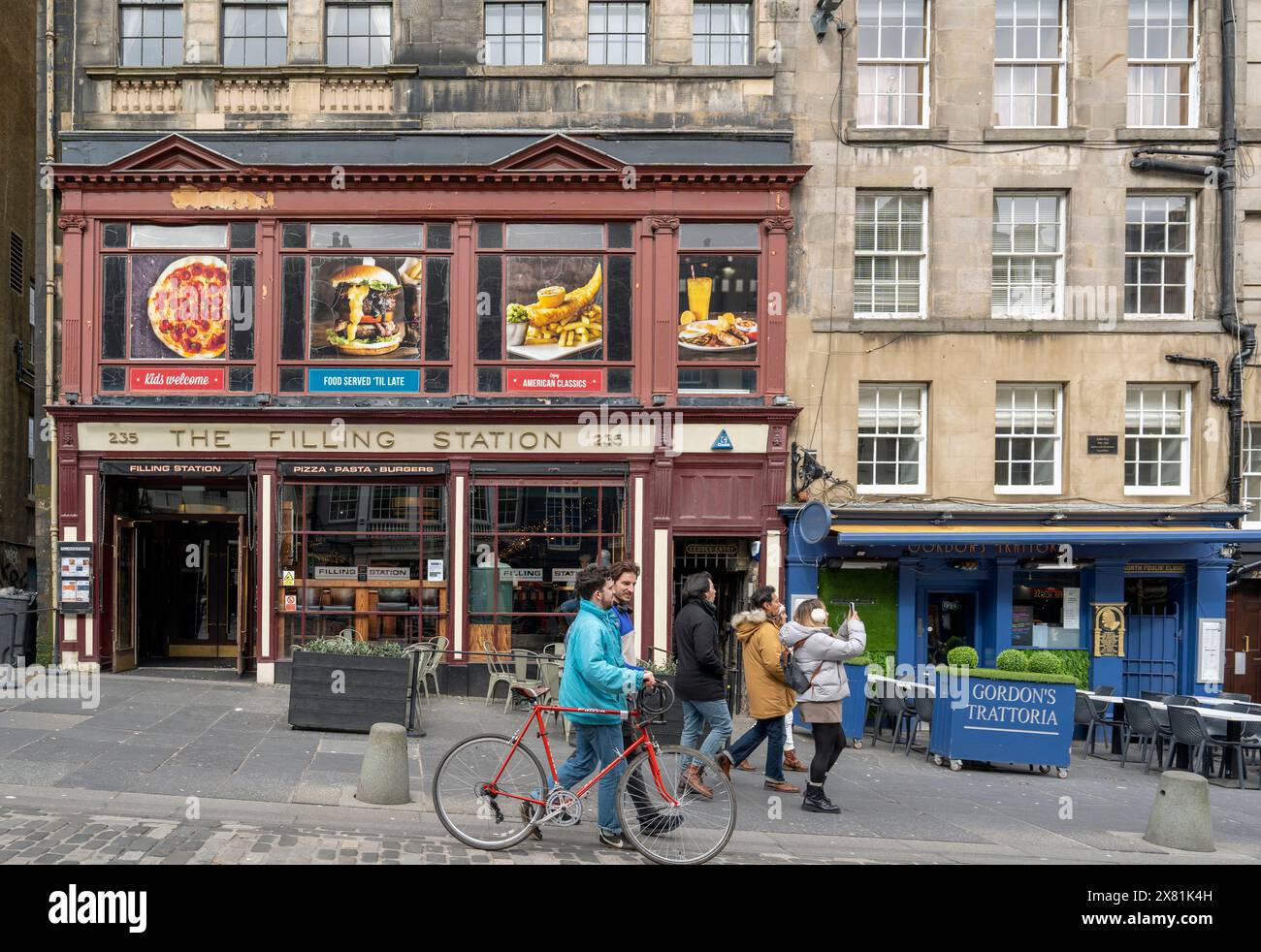 Edinburgh Street Scene - Tourists walk past The Filling Station and ...