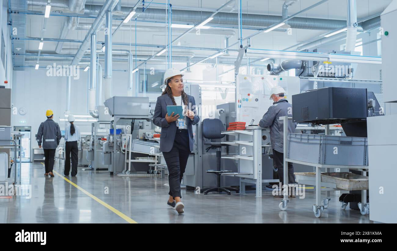 Portrait of a Black Female Engineer in Hard Hat Walking and Using ...