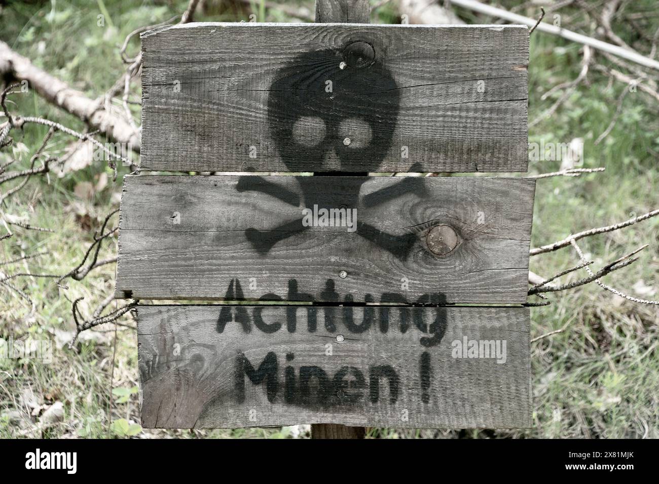 Wooden sign with the inscription "Achtung Minen". Be careful, mines ...