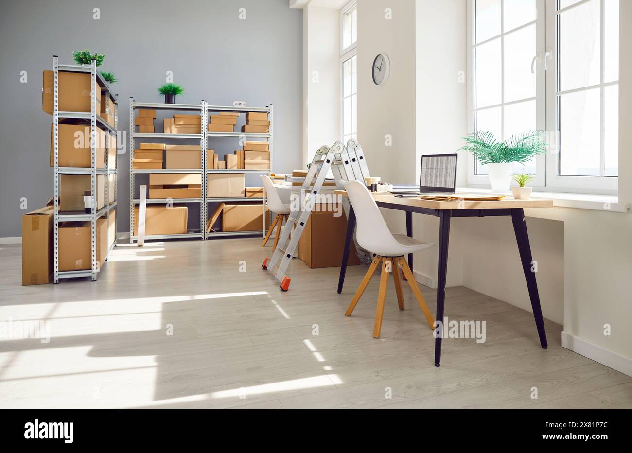 Empty space with office desk in warehouse with shelves filled cardboard ...