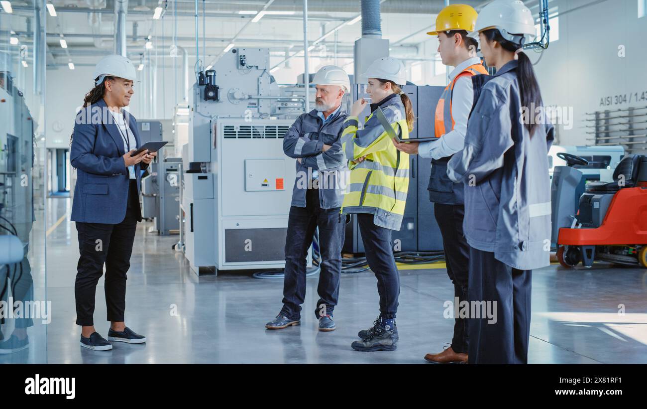 Factory Meeting: Black Female Chief Engineer Talking to Colleagues ...